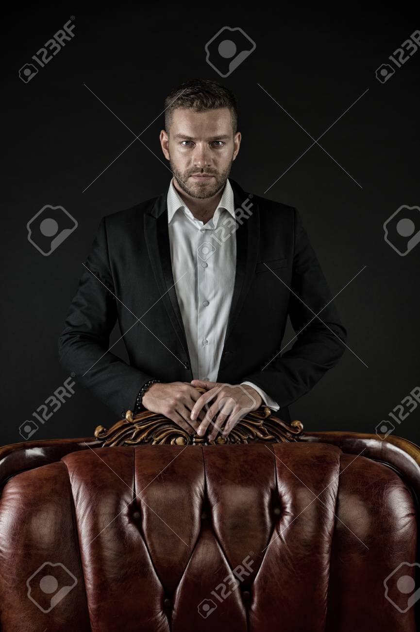 Free download Confidence And Charisma Man Stand At Leather Armchair On ...