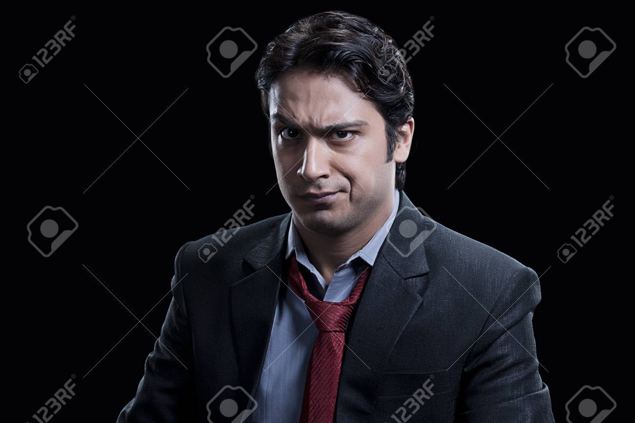 Free download Portrait Of Suspicious Businessman Against Black ...